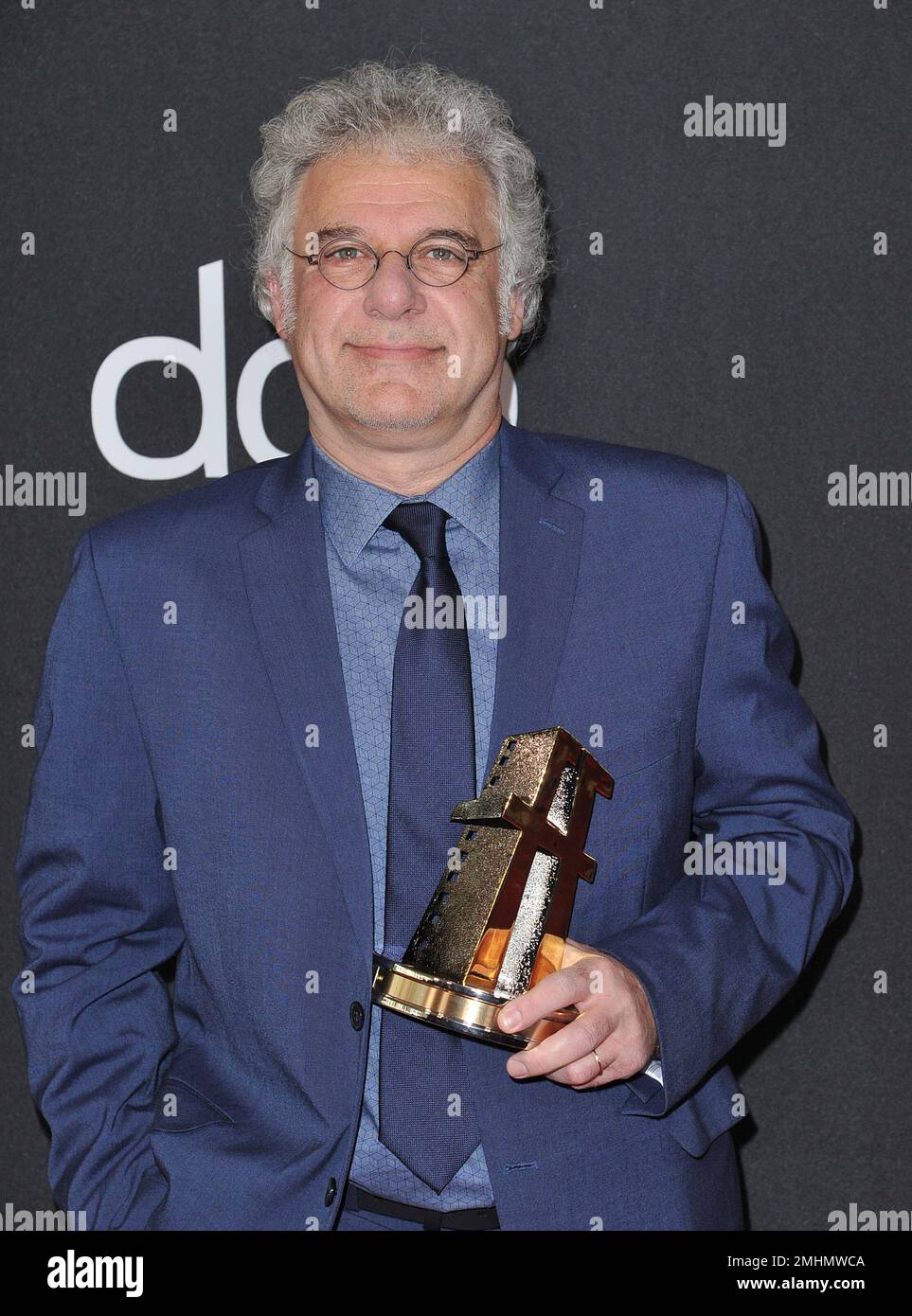 Pablo Helman, holds the award for visual effects for "Irishman" as he ...