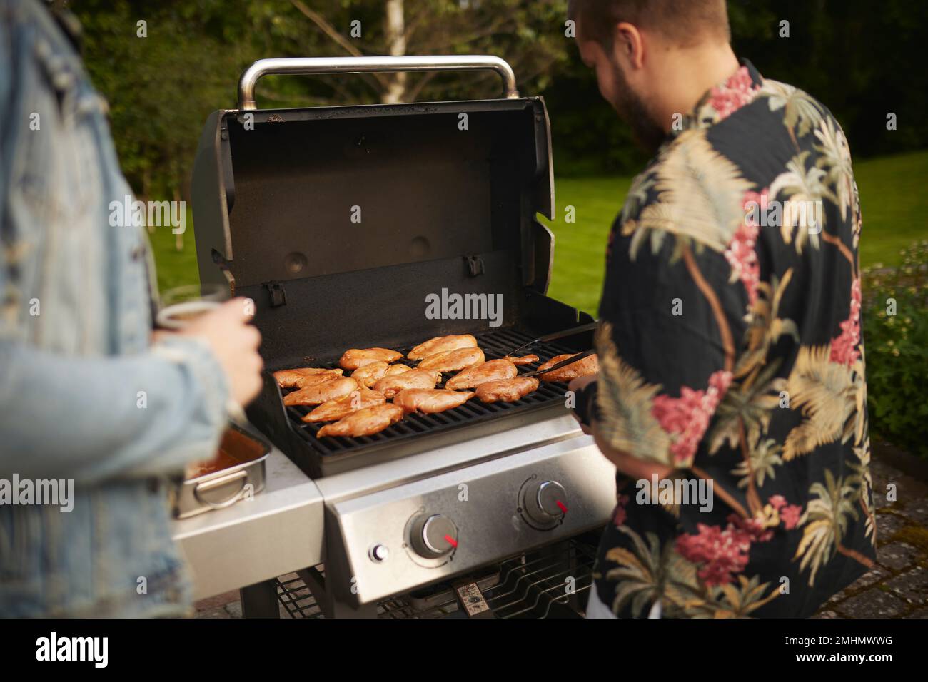 Person at barbecue hi-res stock photography and images - Alamy