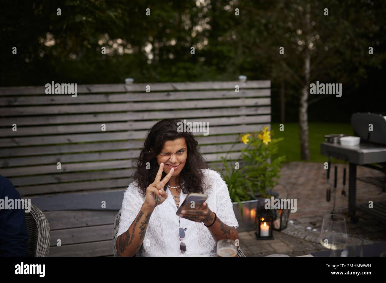 Smiling man showing peace sign Stock Photo - Alamy