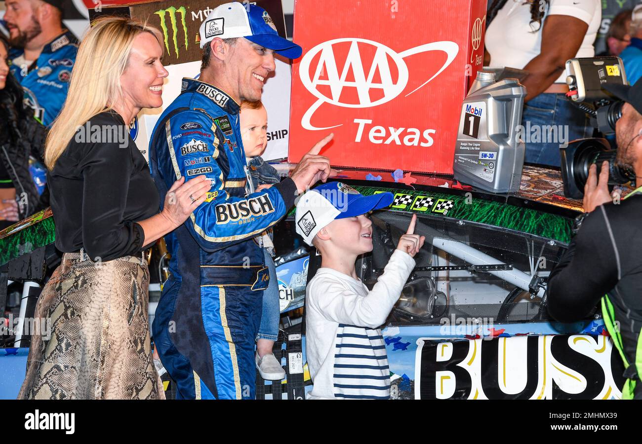 Kevin Harvick and his family celebrate in Victory Lane after winning a ...