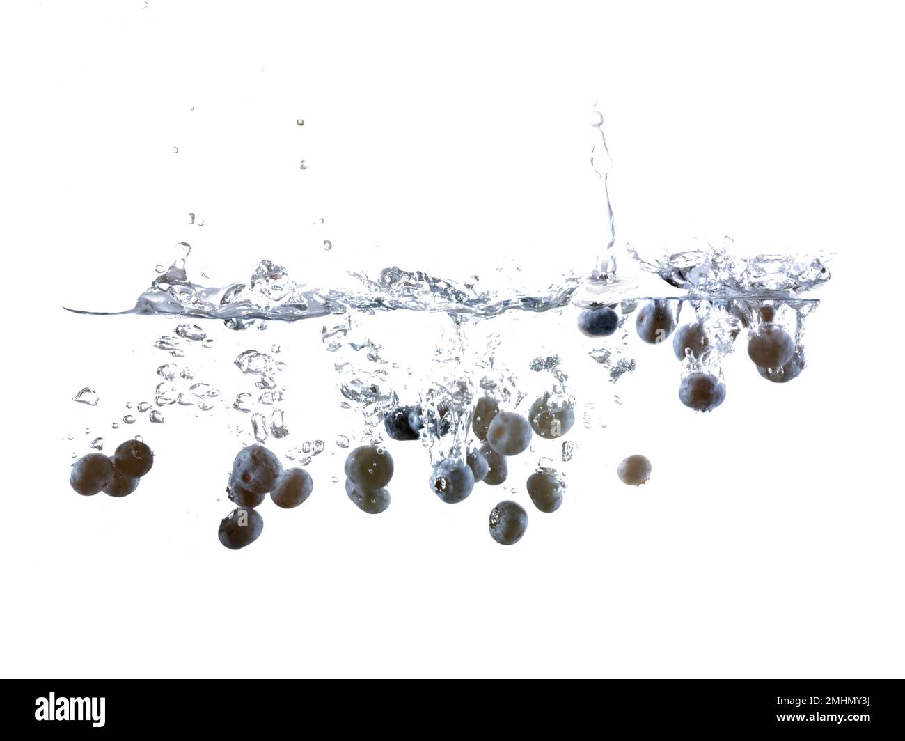 Blueberries sinking into water with air bubbles white background Stock ...