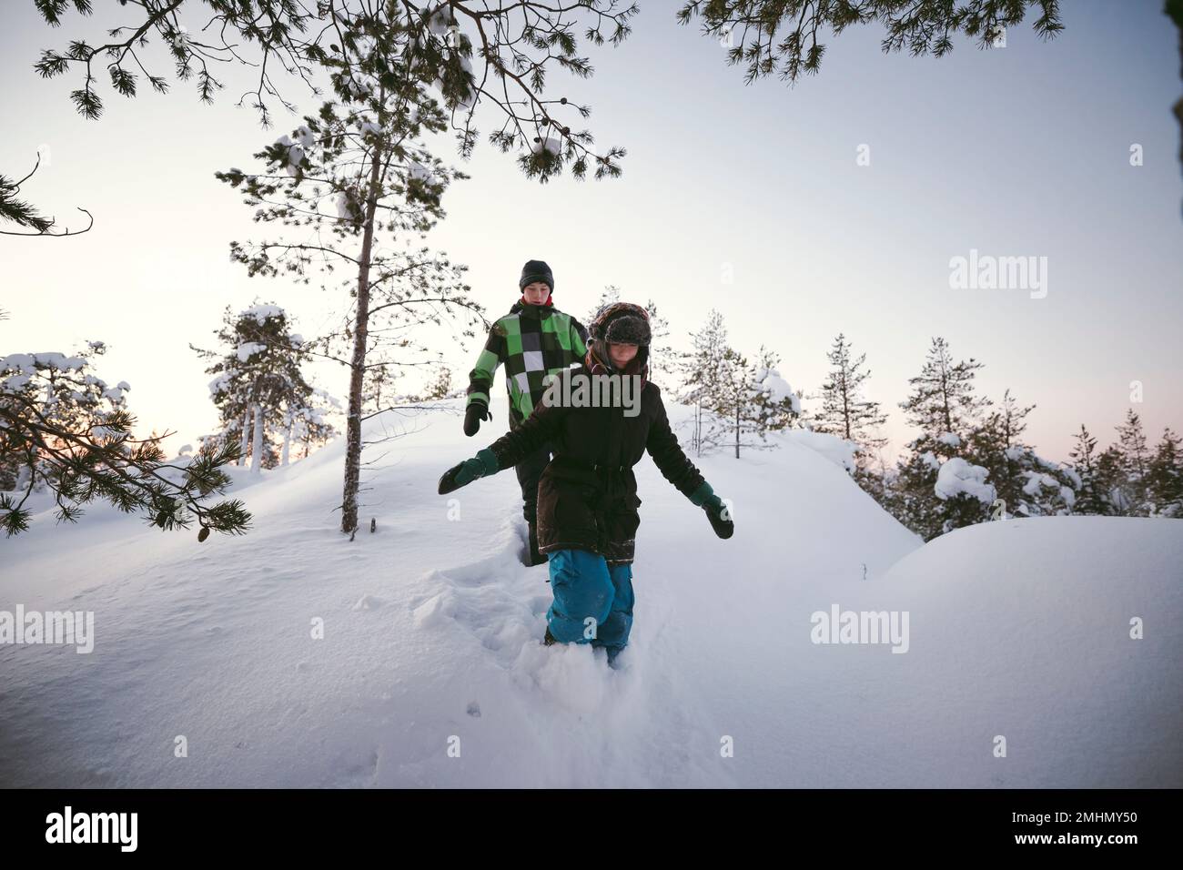 Two friends walking together in winter scenery Stock Photo - Alamy