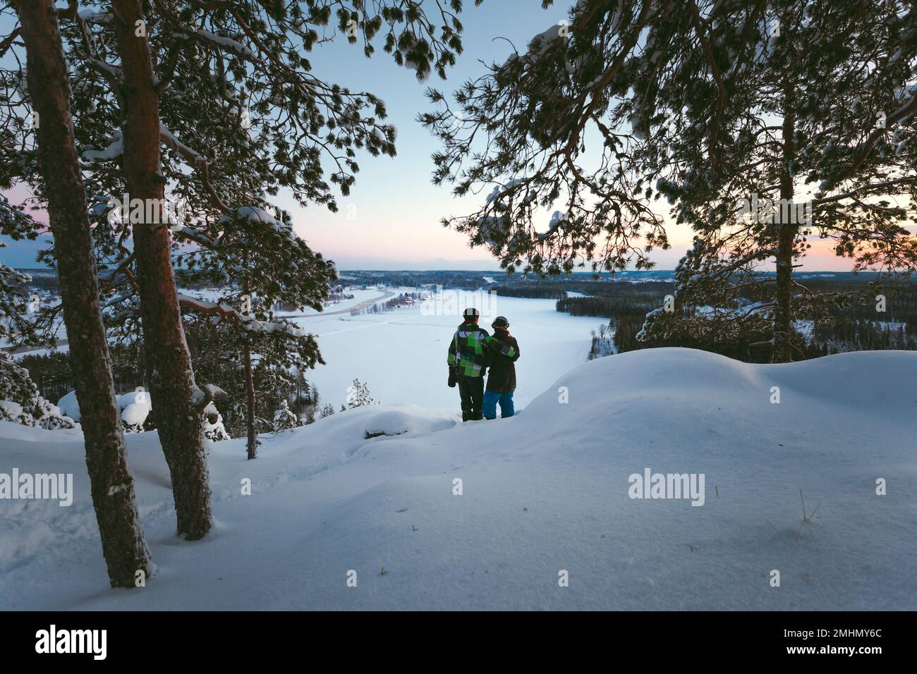 Two friends standing together in winter scenery Stock Photo - Alamy