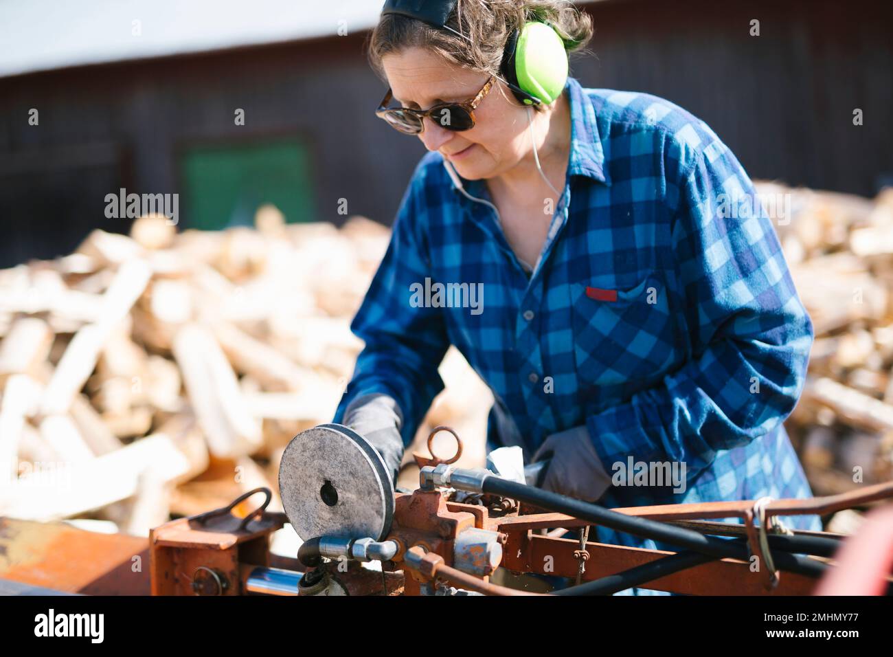 Mature woman working in sawmill Stock Photo - Alamy