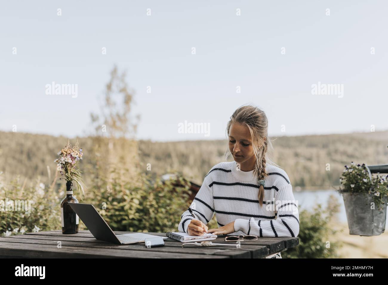 Young woman taking notes Stock Photo - Alamy