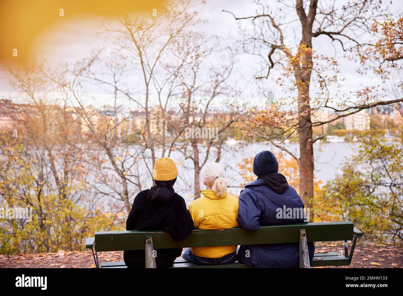 Three friends in park in autumn scenery Stock Photo - Alamy