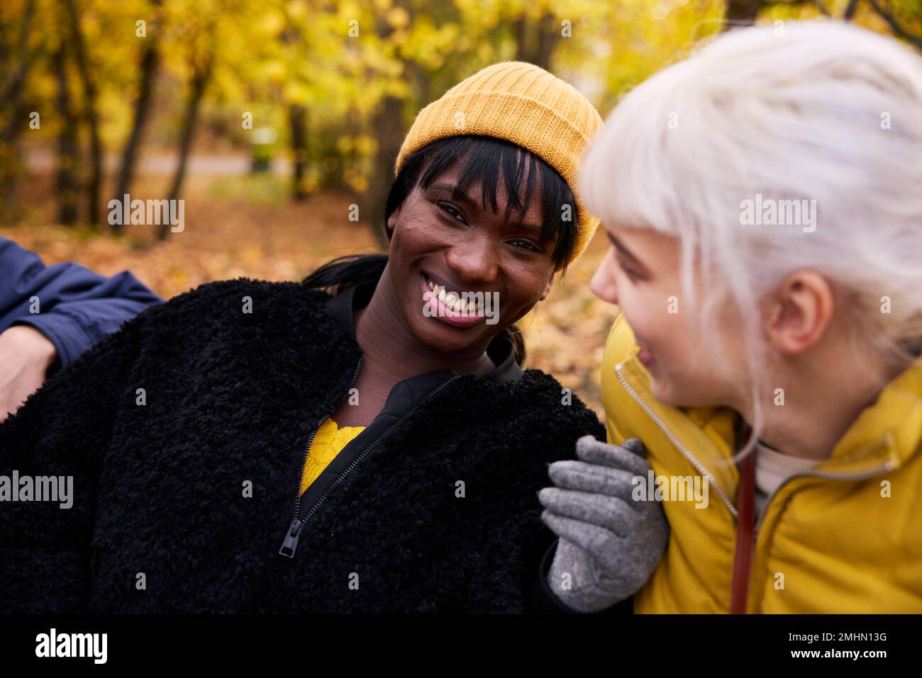 Two friends in park in autumn scenery Stock Photo - Alamy