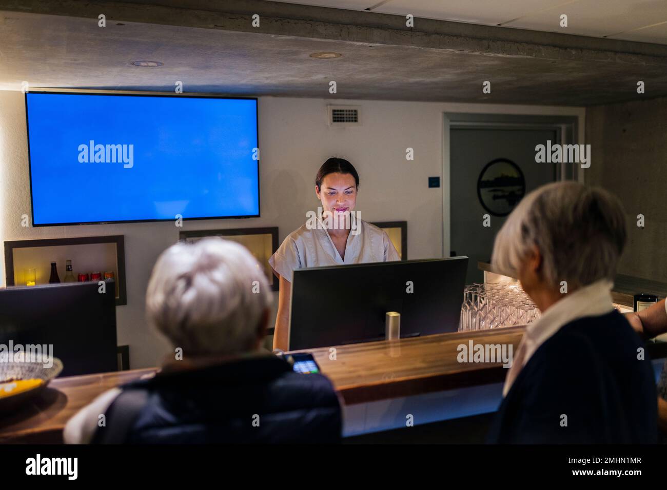 Receptionist assisting customer at health spa Stock Photo - Alamy