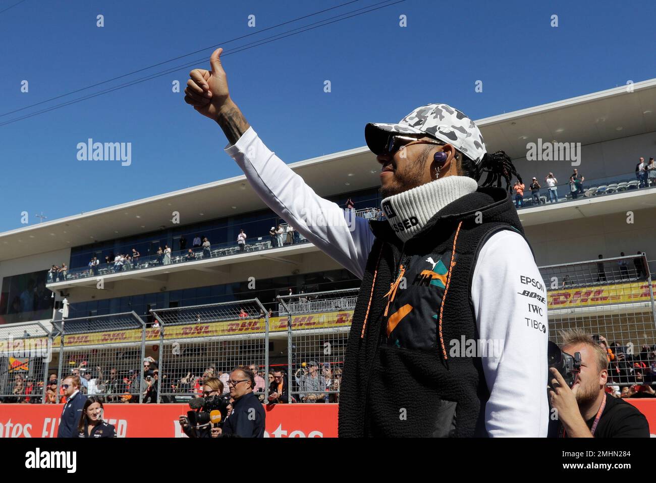 Mercedes driver Lewis Hamilton, of Britain, gives the thumbs up to fans ...