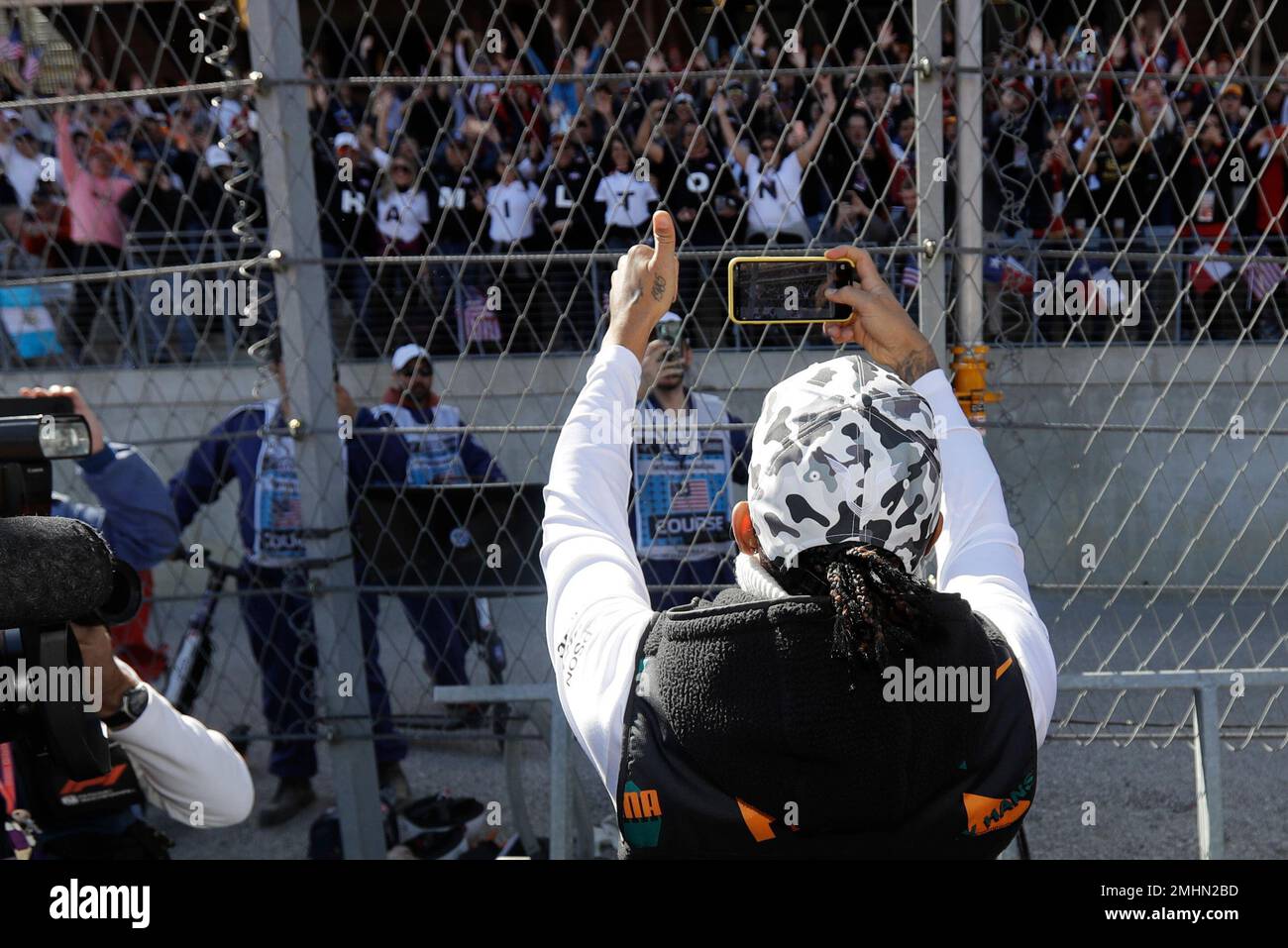 Mercedes driver Lewis Hamilton, of Britain, gives the thumbs up to fans ...