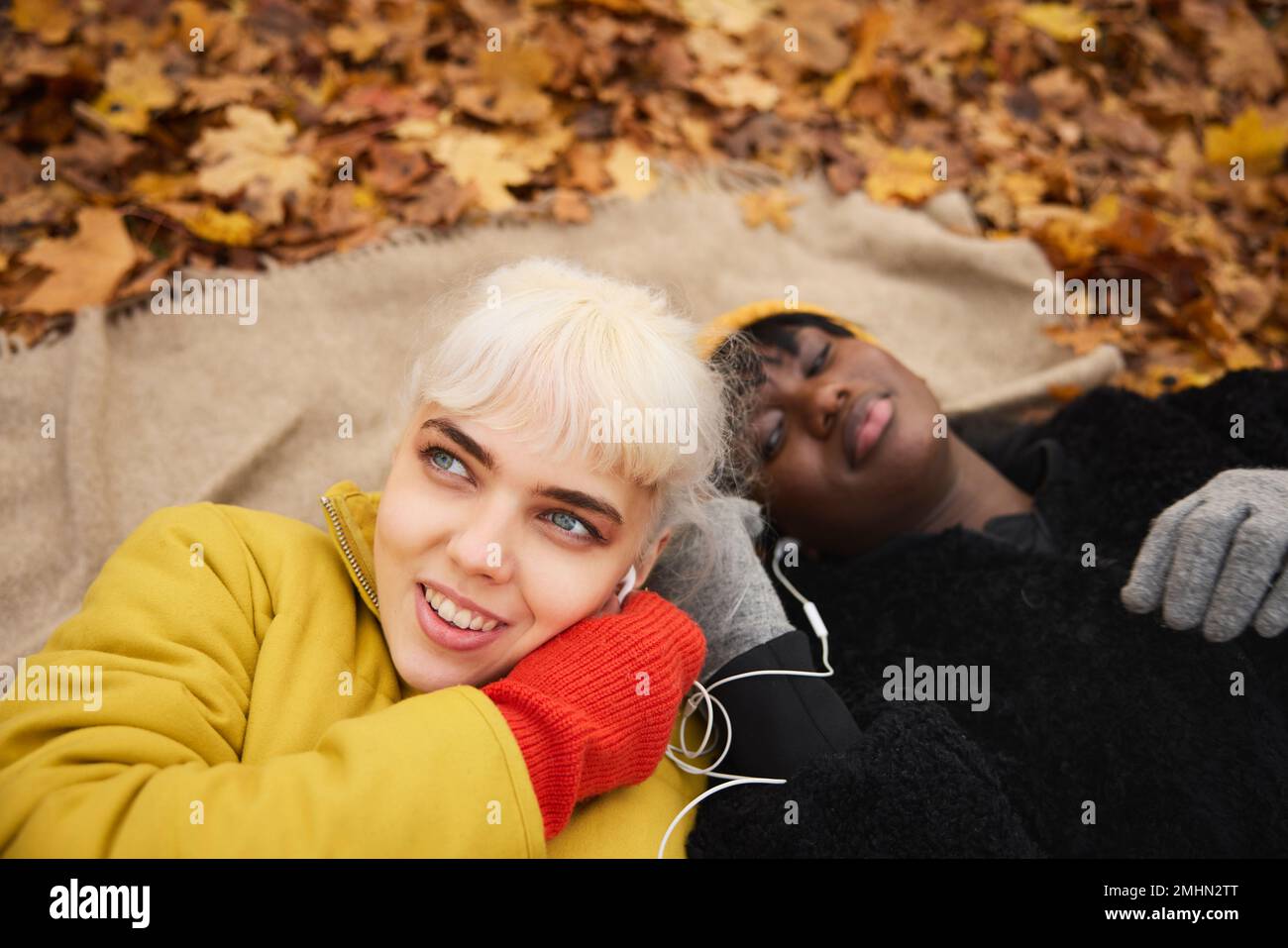 Female friends lying together Stock Photo - Alamy
