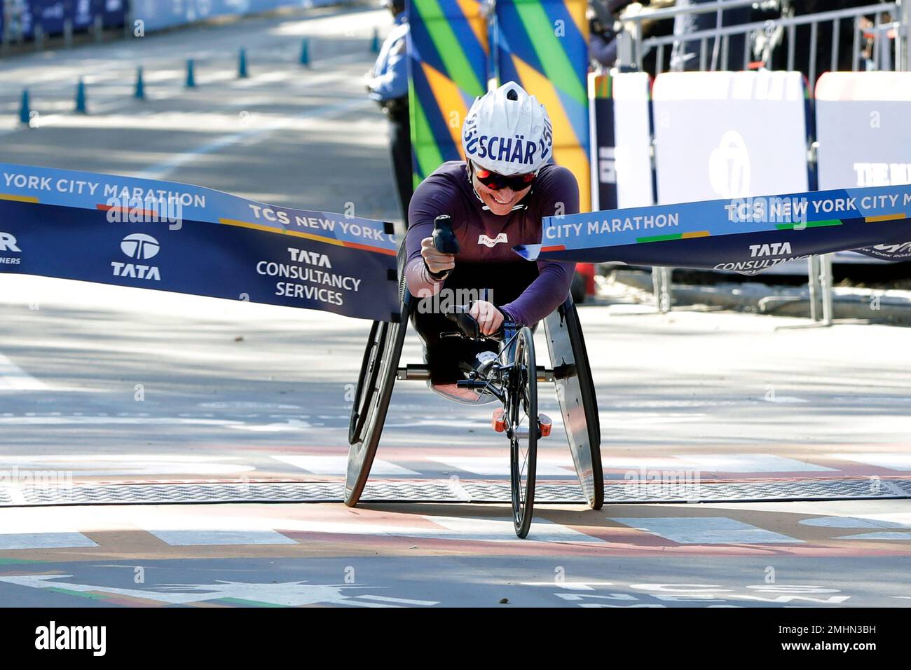 Manuela Schar, of Switzerland, crosses the finish line to win the pro ...