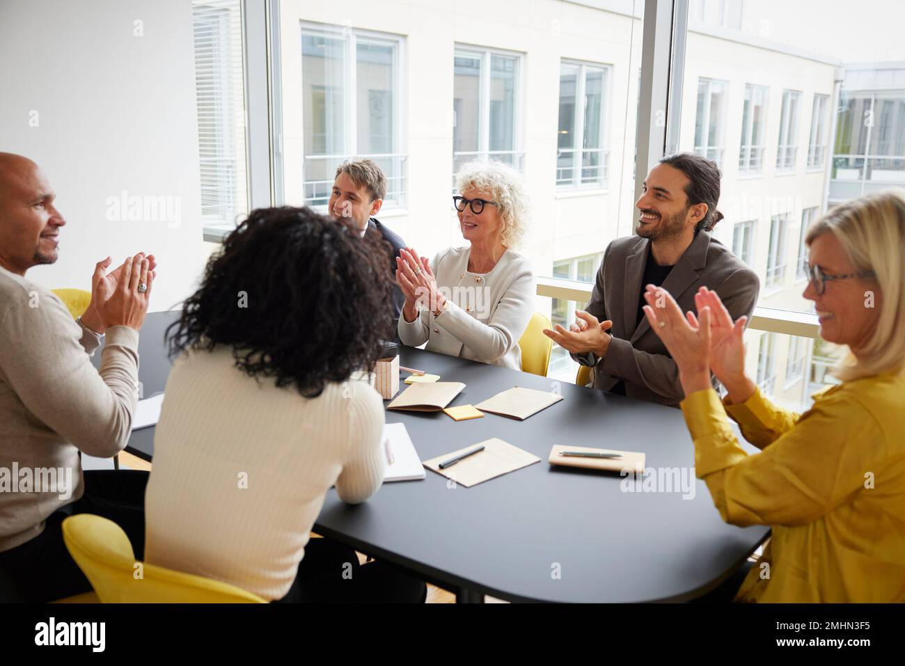 Business people clapping during meeting in office Stock Photo - Alamy