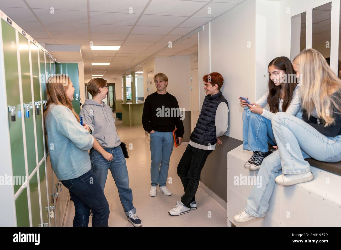 Teenage kids in school locker room Stock Photo - Alamy