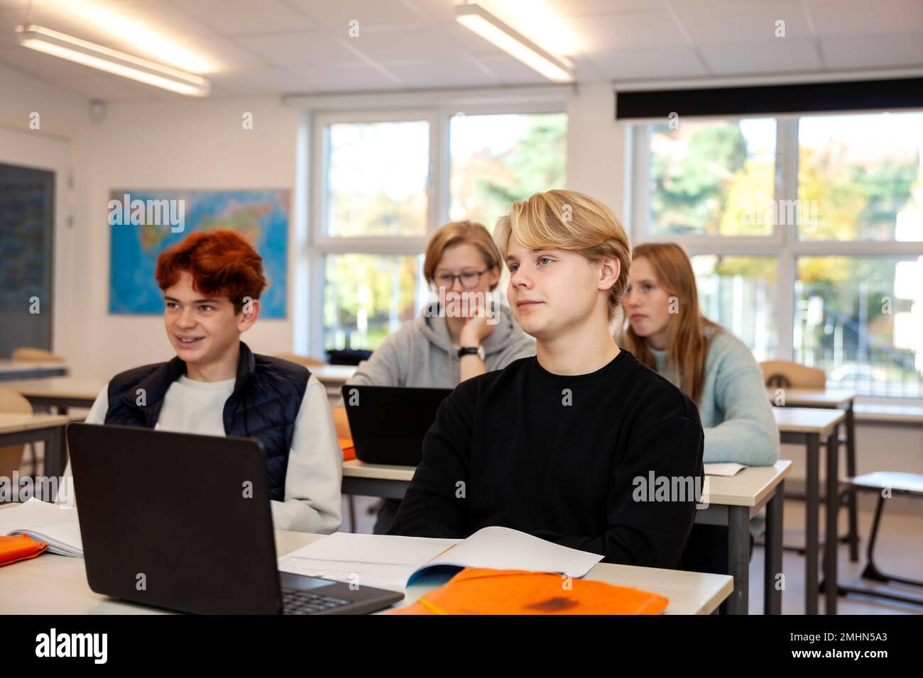 Teenage boys using laptops in classroom Stock Photo - Alamy