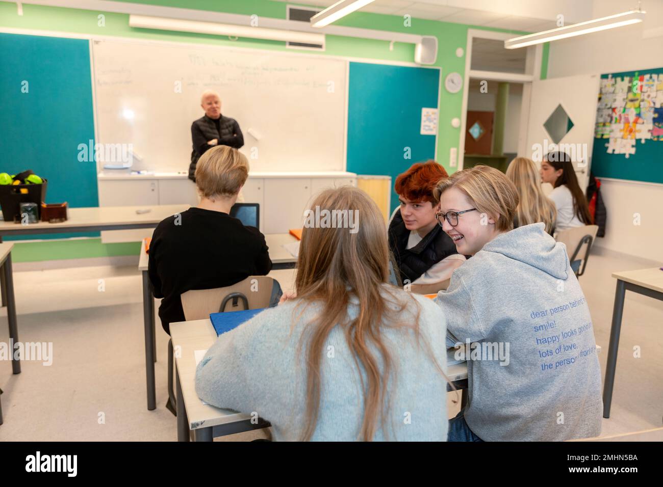 Teenage kids and teacher in classroom Stock Photo - Alamy