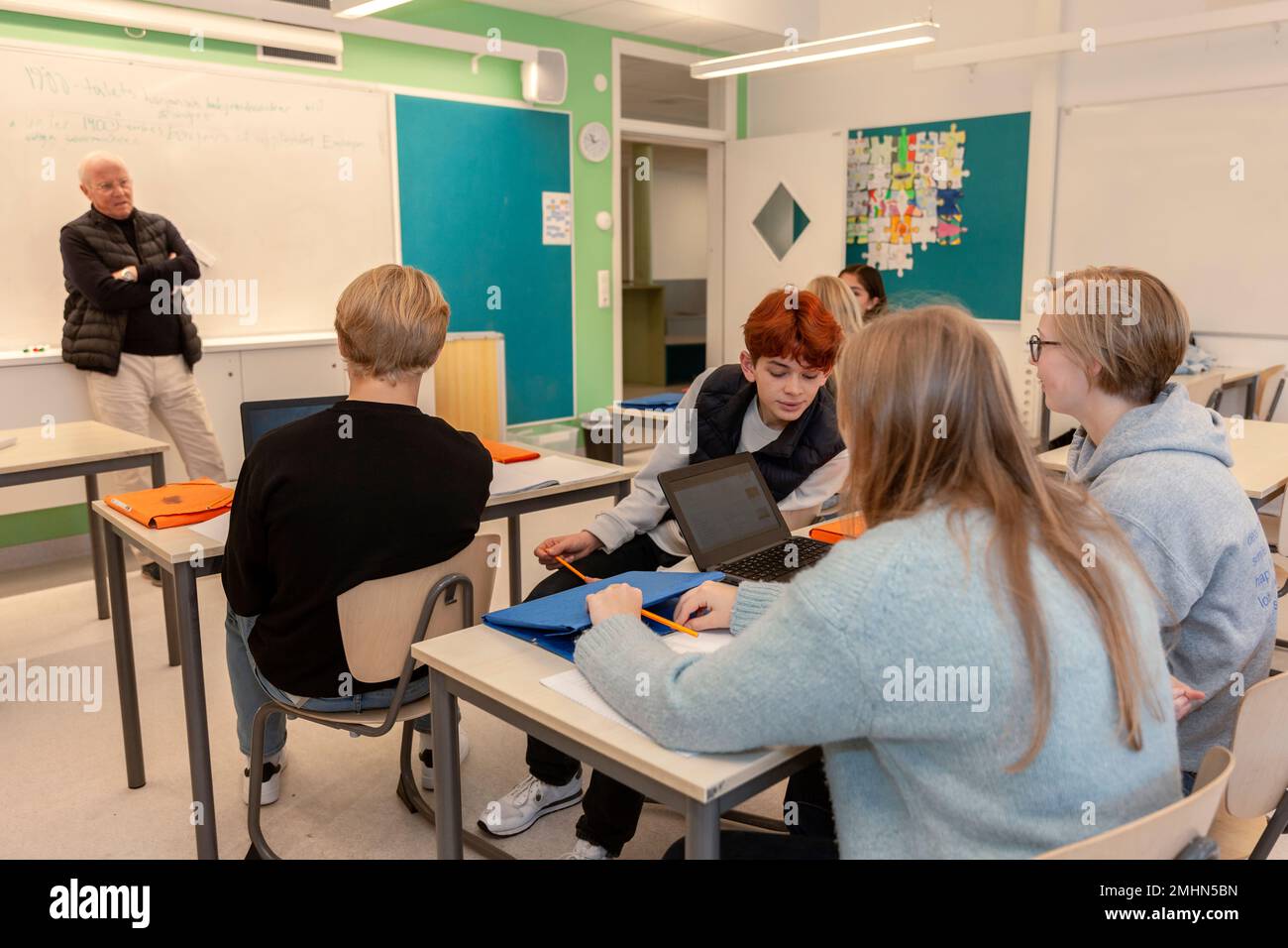 Teenage kids and teacher in classroom Stock Photo - Alamy