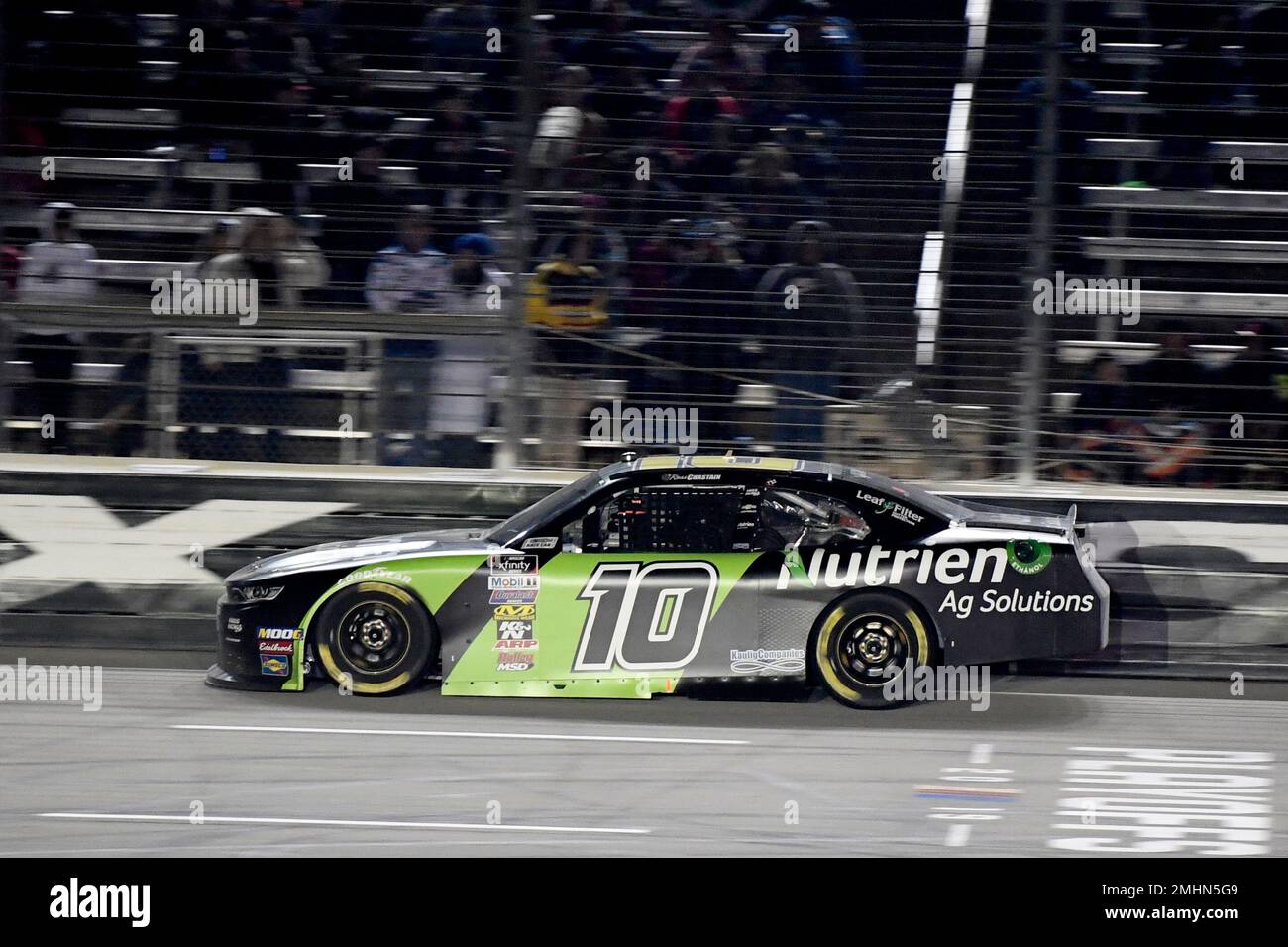 Fans look on as Ross Chastain speeds down the front stretch during the ...