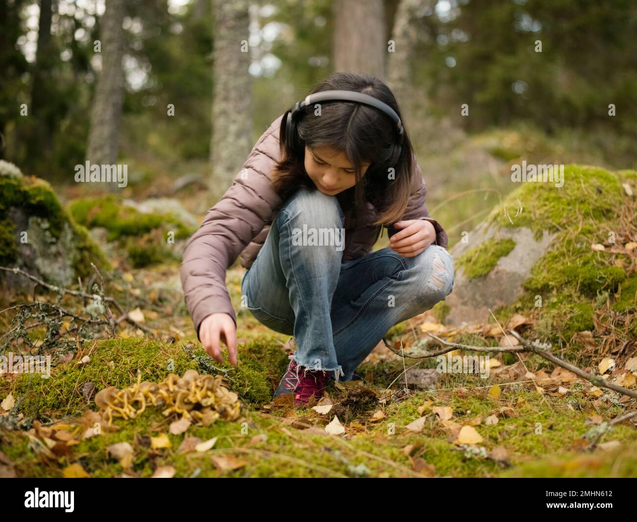 Girl wearing headphones in forest Stock Photo - Alamy