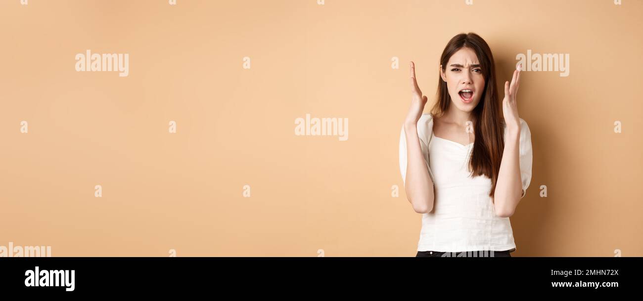 Frustarted woman shouting and shaking hands angry, looking mad ...