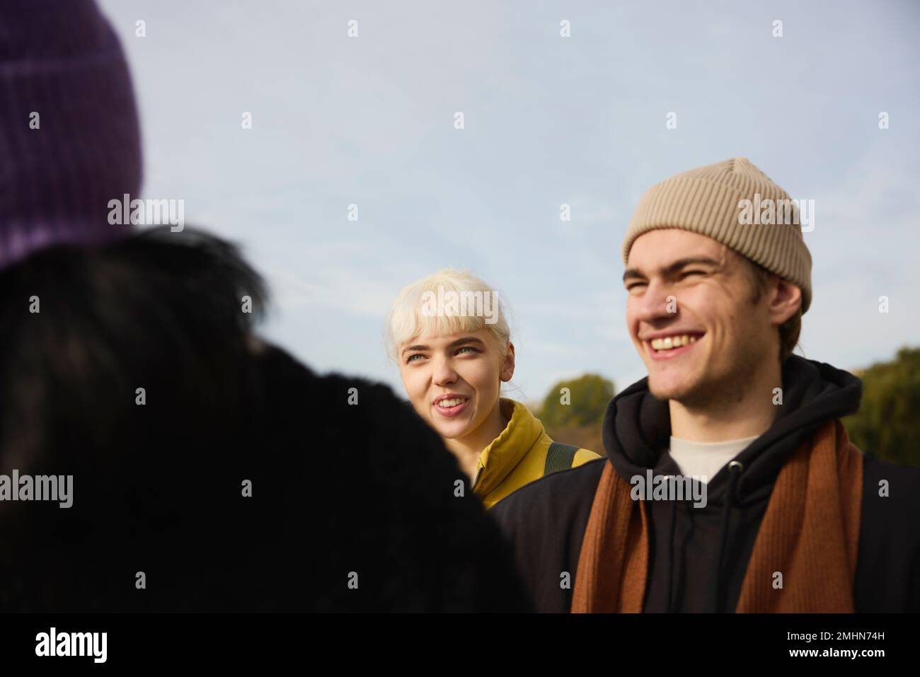 Smiling friends talking together Stock Photo - Alamy