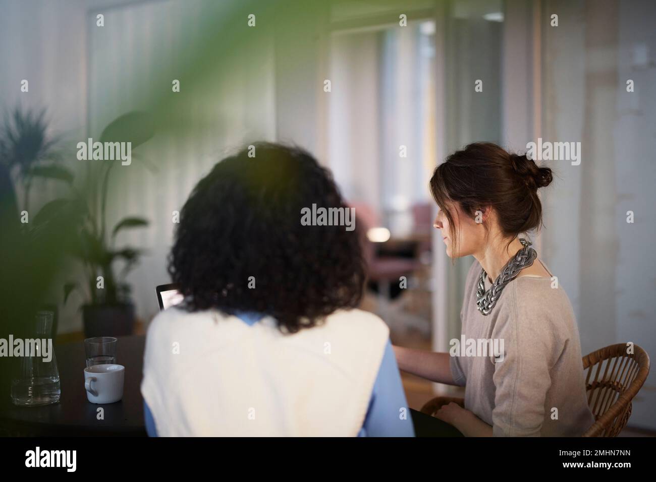 Women talking in cafeteria Stock Photo - Alamy