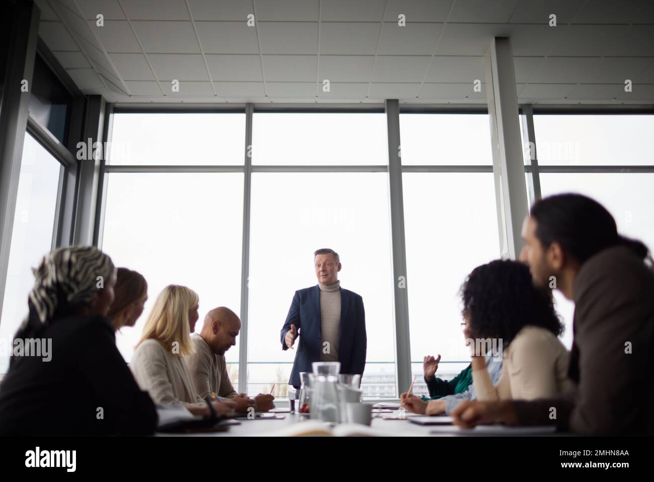 Man talking during business meeting Stock Photo - Alamy