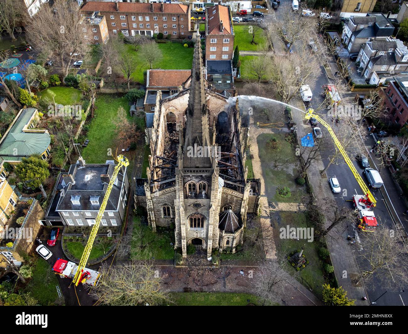 London, UK. Jan 27th 2023. Aerial view of burnt church as firefighters ...