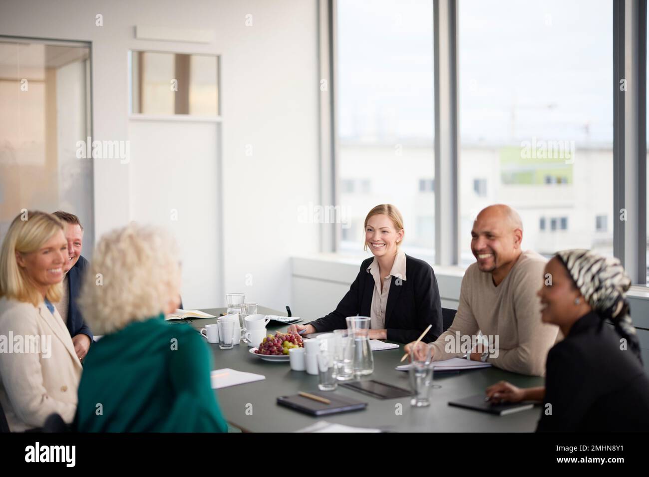Smiling people at business meeting Stock Photo - Alamy
