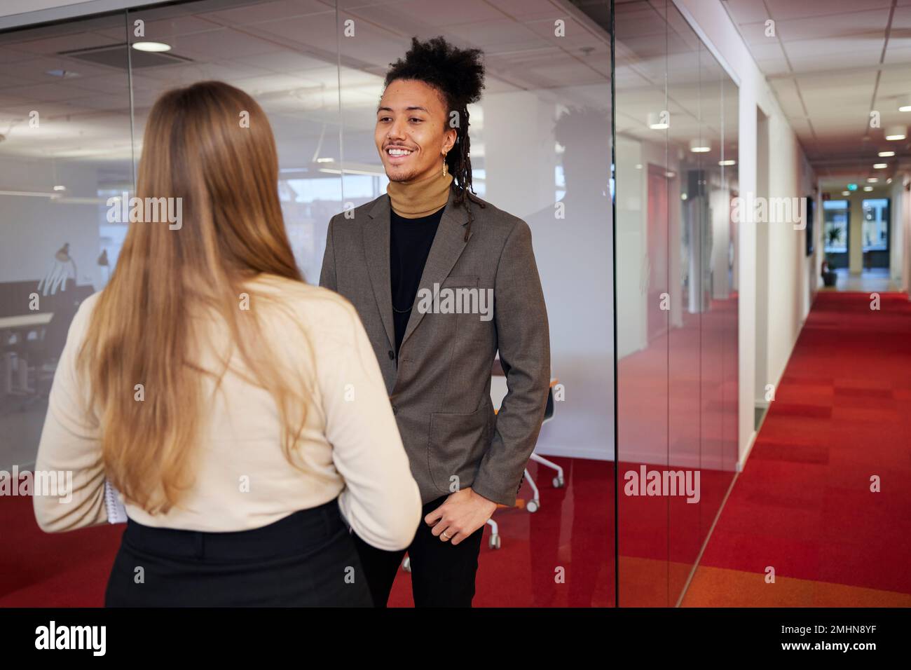 Business people talking in office corridor Stock Photo - Alamy