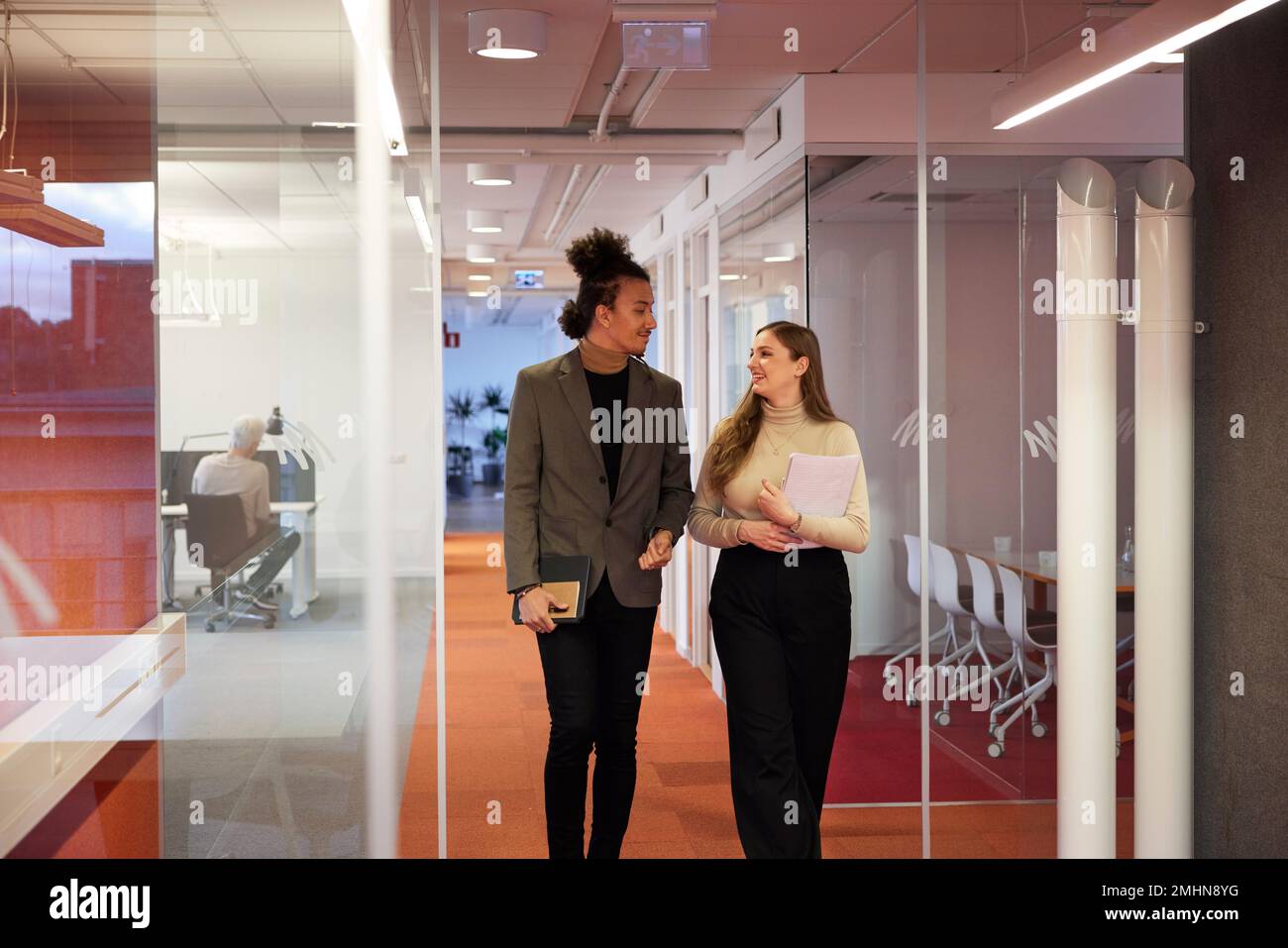 Business people walking in office corridor Stock Photo - Alamy