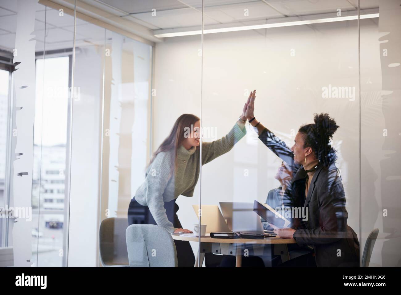 Business people high fiving during meeting in office Stock Photo - Alamy