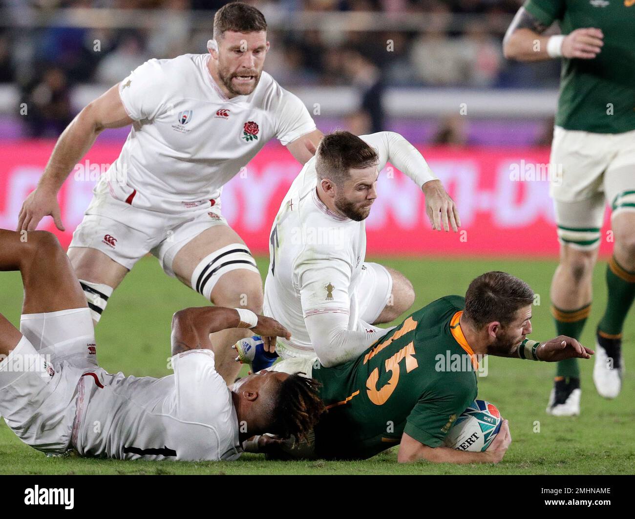 South Africa's Willie Le Roux, right, is brought down by England's ...