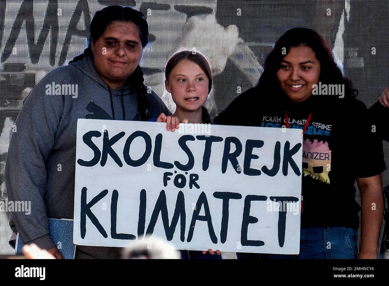 Climate activist Greta Thunberg, center, holding a sign, poses photos ...
