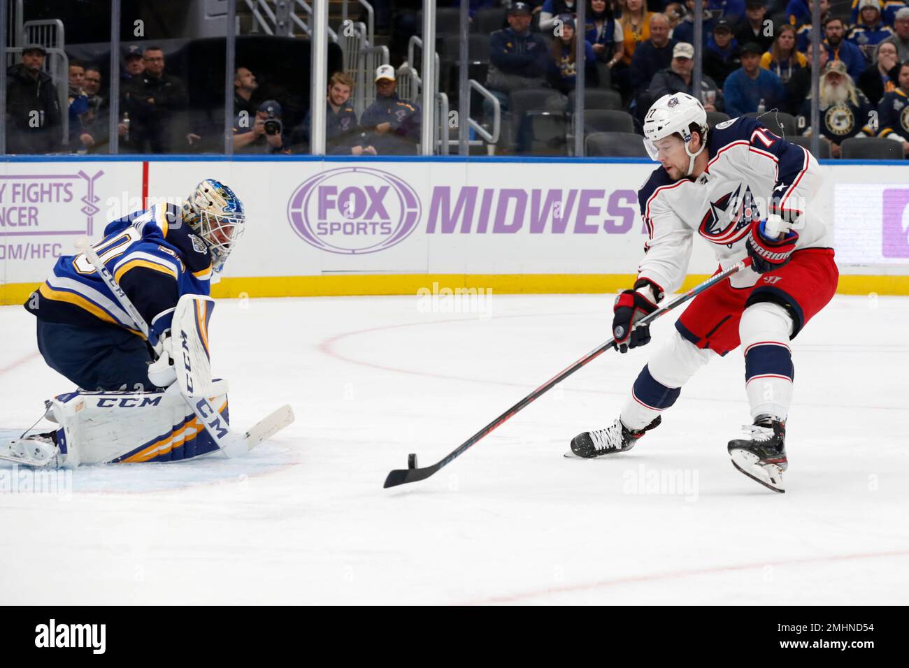 Columbus Blue Jackets' Josh Anderson, right, shoots as St. Louis Blues ...