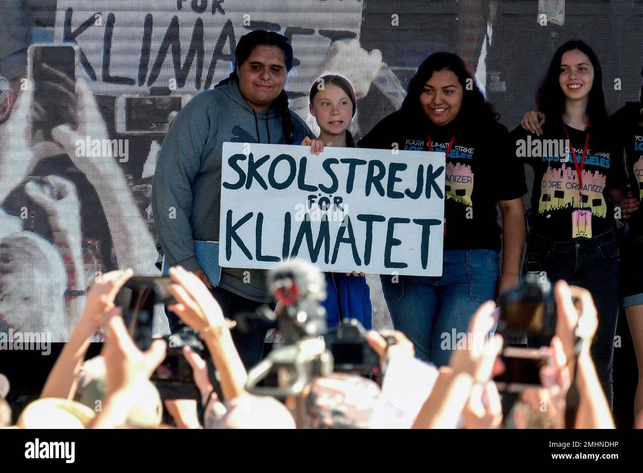Climate activist Greta Thunberg, second from left, holding a sign ...