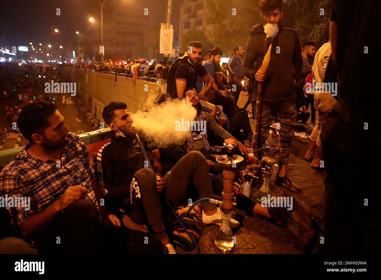 Anti-government protesters rest and smoke a waterpipe during during ...