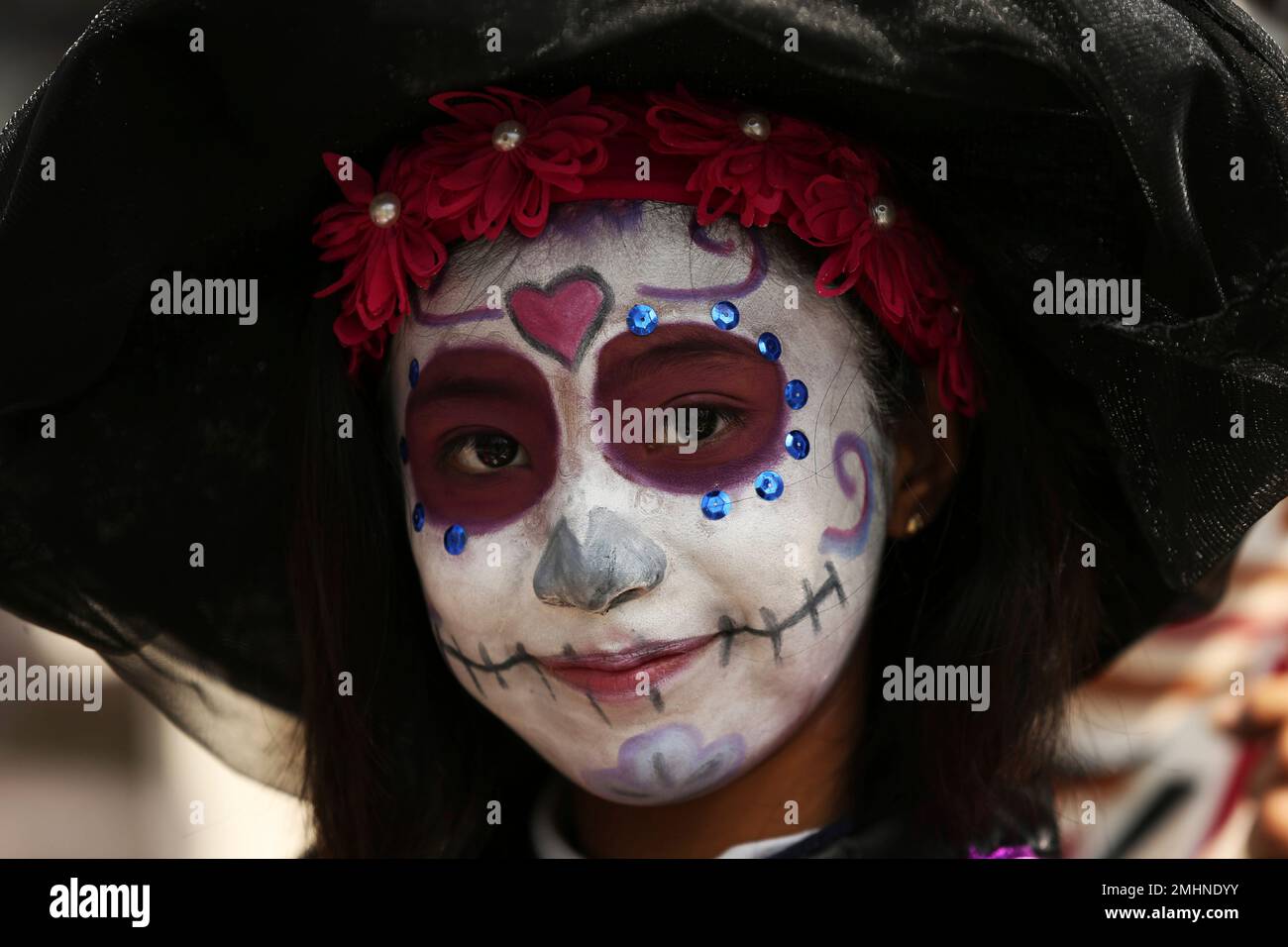 A child dressed in a Catrina costume posed for a photo during Day of ...