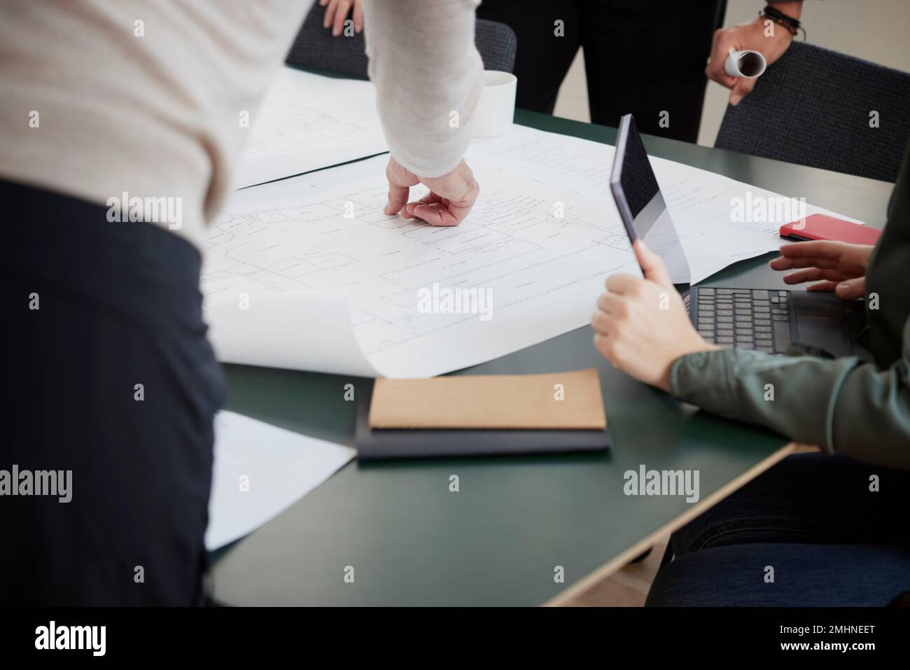 People looking at plans during meeting Stock Photo - Alamy