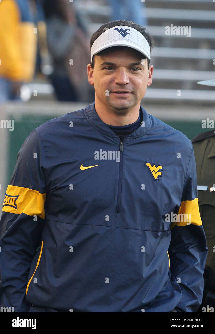 West Virginia head coach Neal Brown heads to the sideline before an ...