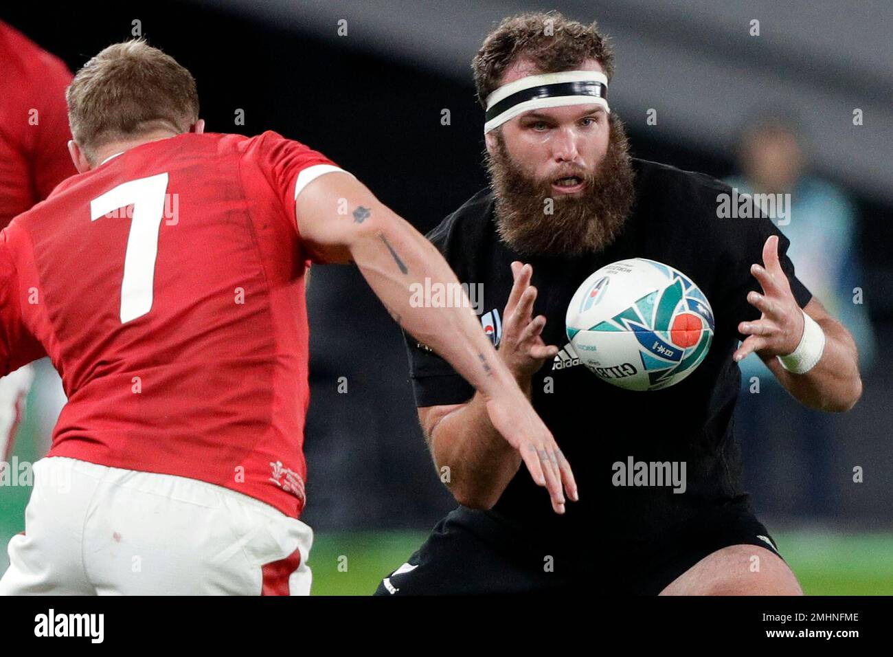 New Zealand's Liam Coltman catches the ball past Wales' James Davies ...