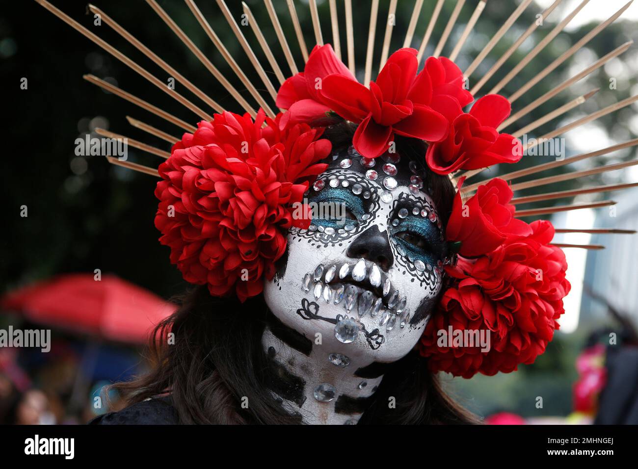 In this Oct. 26, 2019 photo, a woman dressed as a Catrina poses for a ...