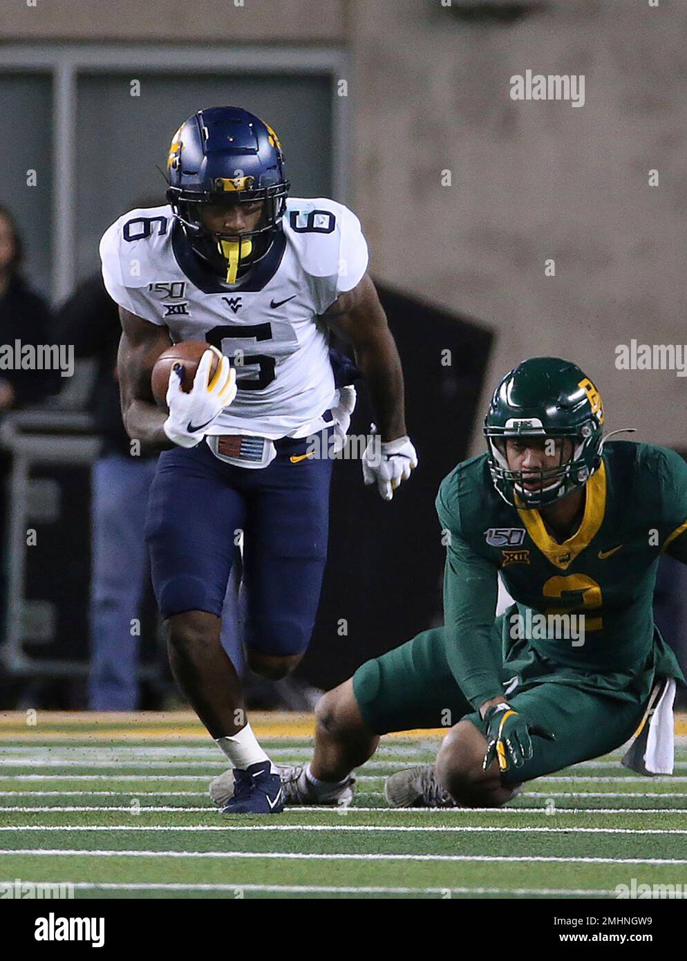 West Virginia running back Kennedy McKoy (6) runs past Baylor ...