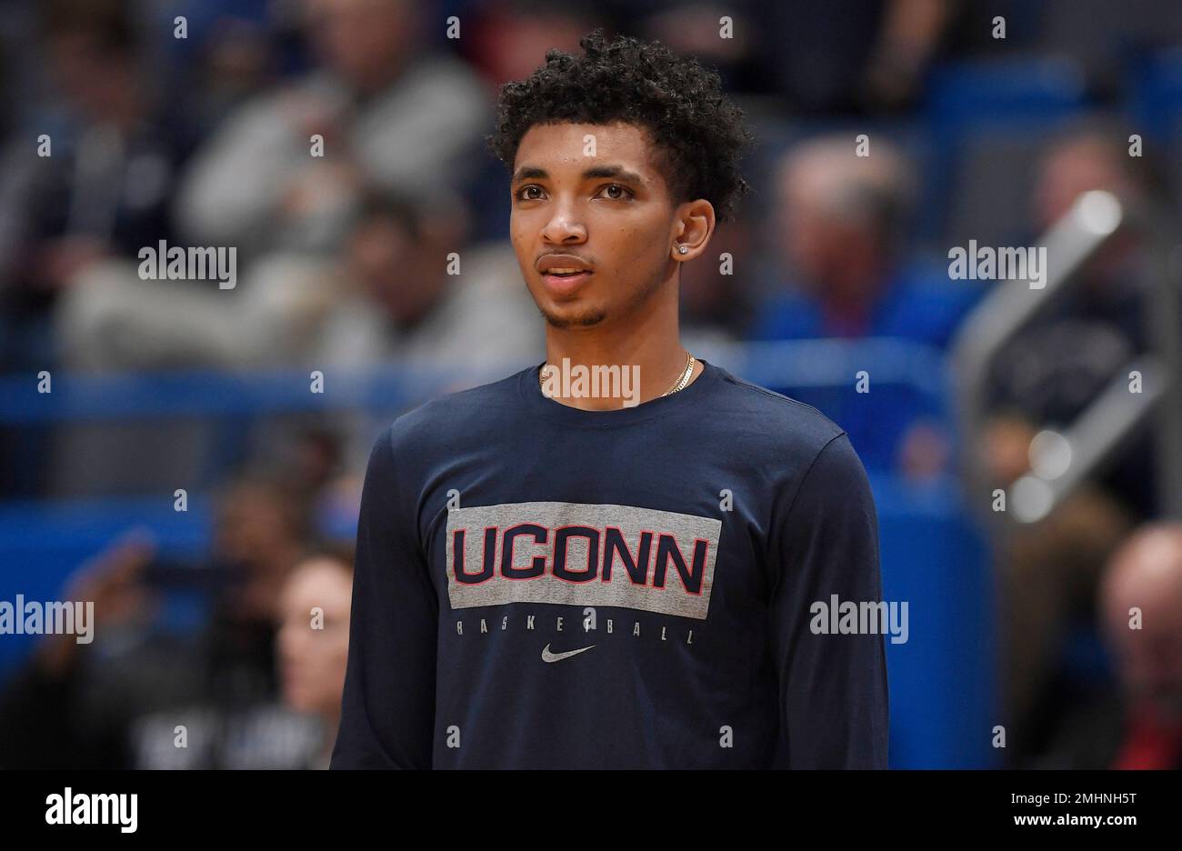Connecticut's James Bouknight watches his team warm up before an ...