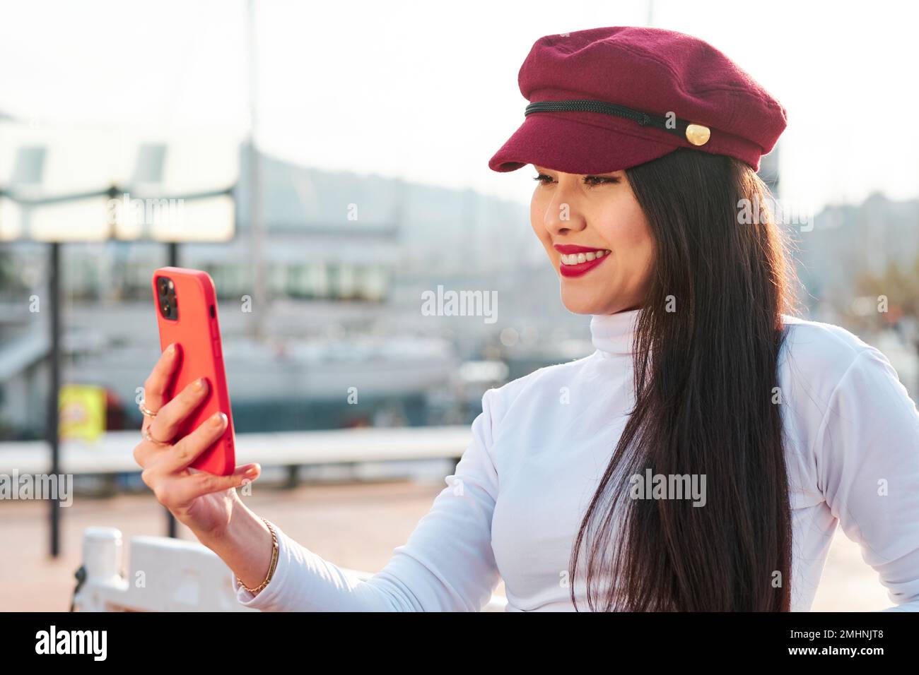 Stylish Woman With Beret Smiling While Taking Selfies With Mobile Phone