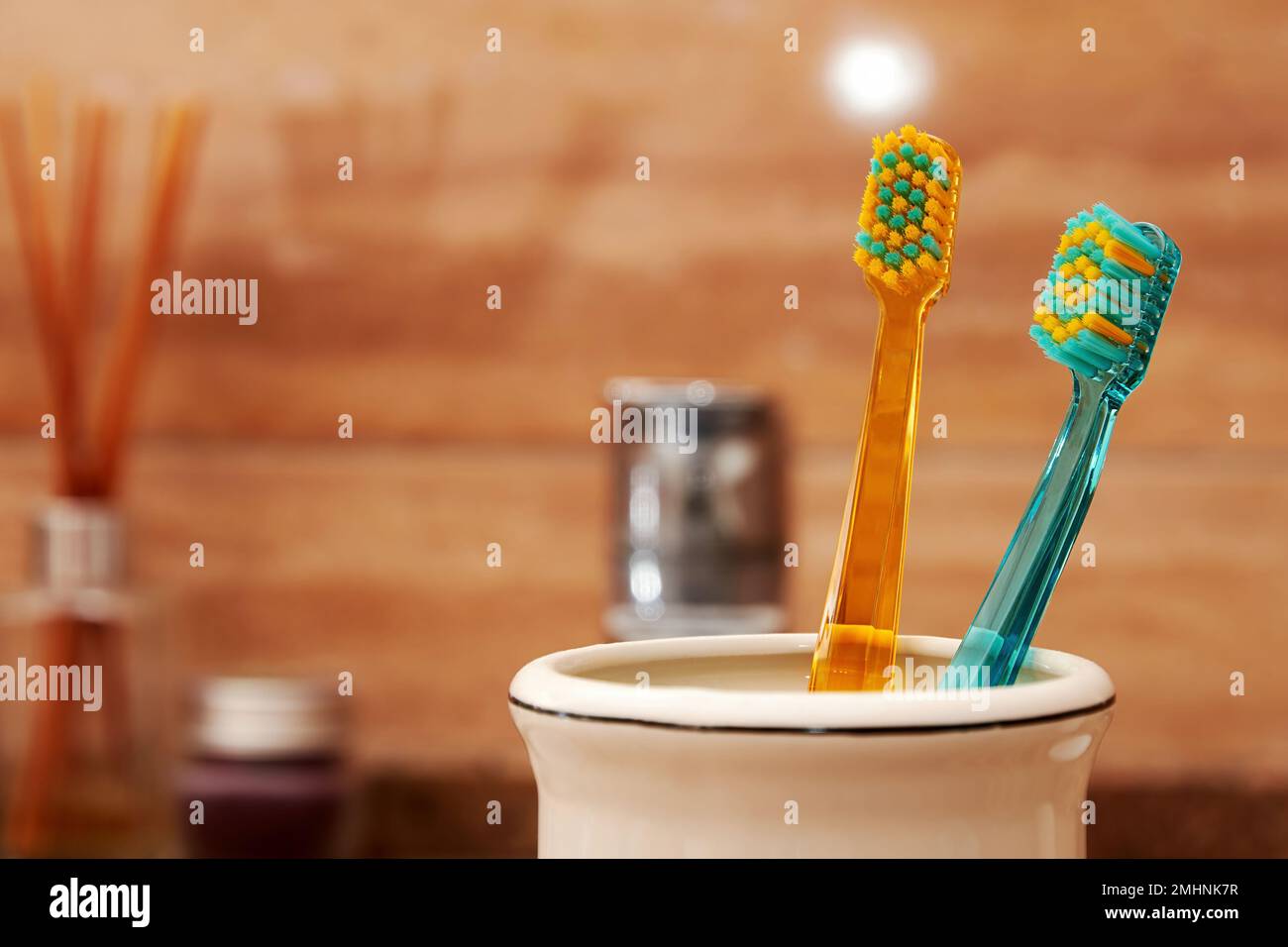 Closeup view of multicolored toothbrushes in the jar on the table in ...