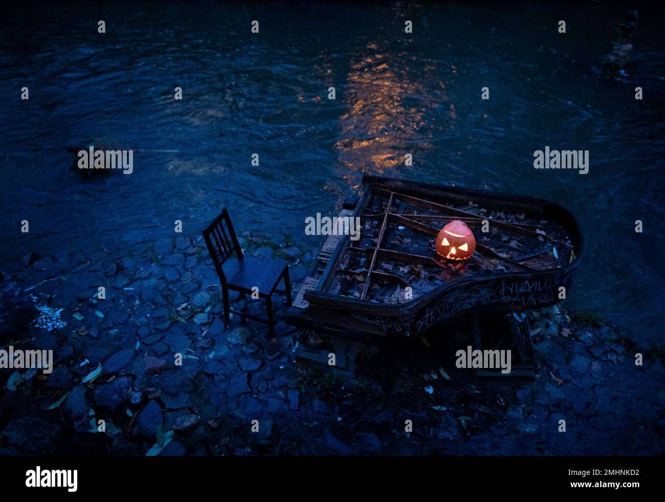 A Halloween carved pumpkin sits on an old piano at the Vilnele river in ...
