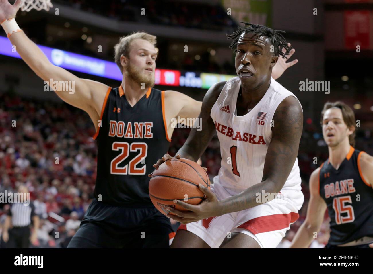 Nebraska's Kevin Cross (1) is guarded by Doane University's Jaxon Harre ...
