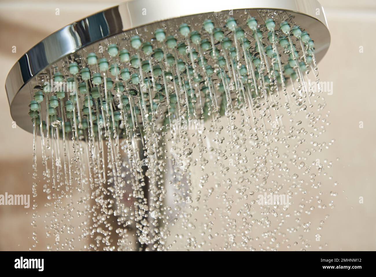 Fast water flow from the chrome shower head in the bath cabin. Bathroom ...