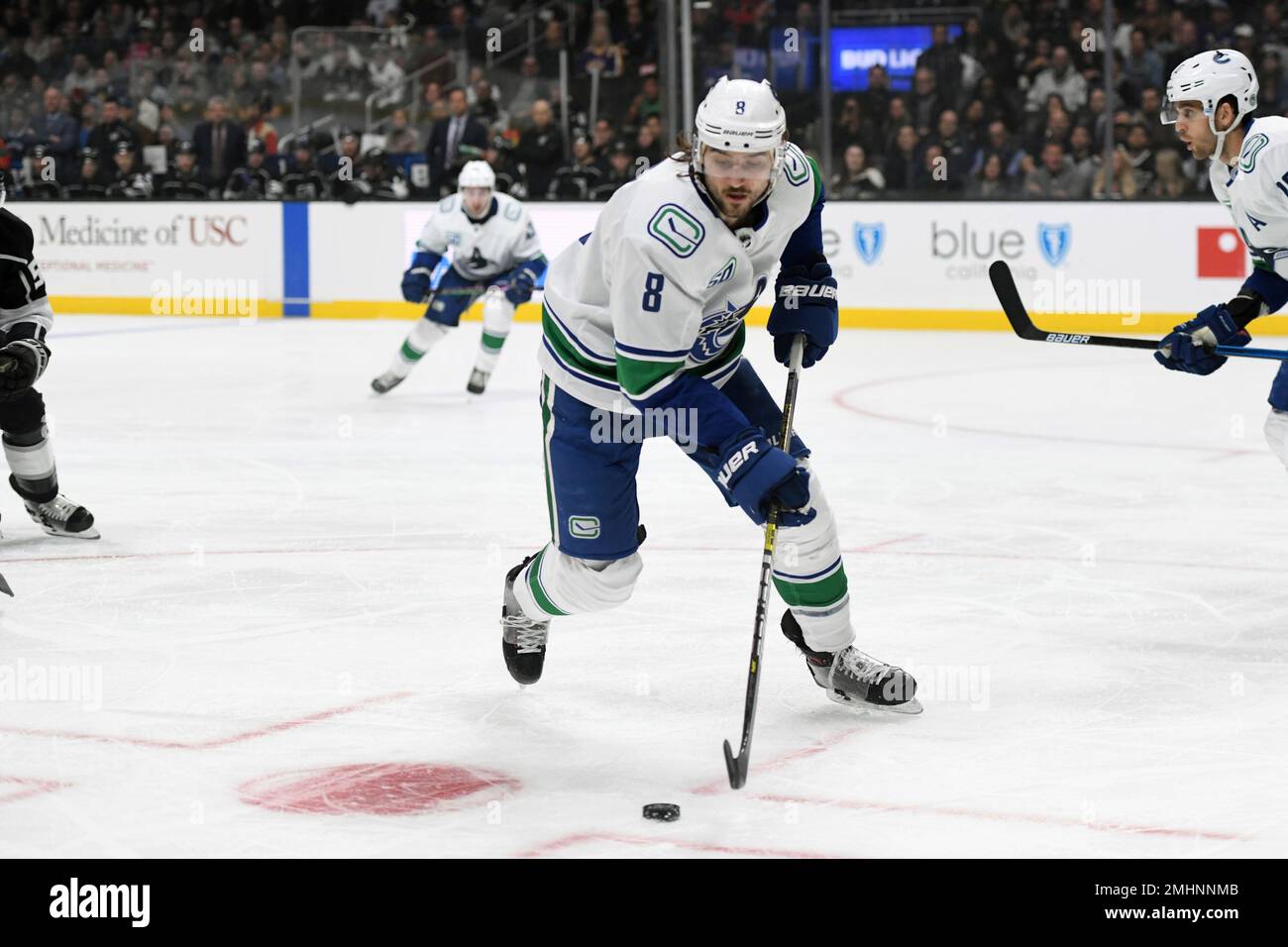 Vancouver Canucks defenseman Christopher Tanev clears the puck against ...